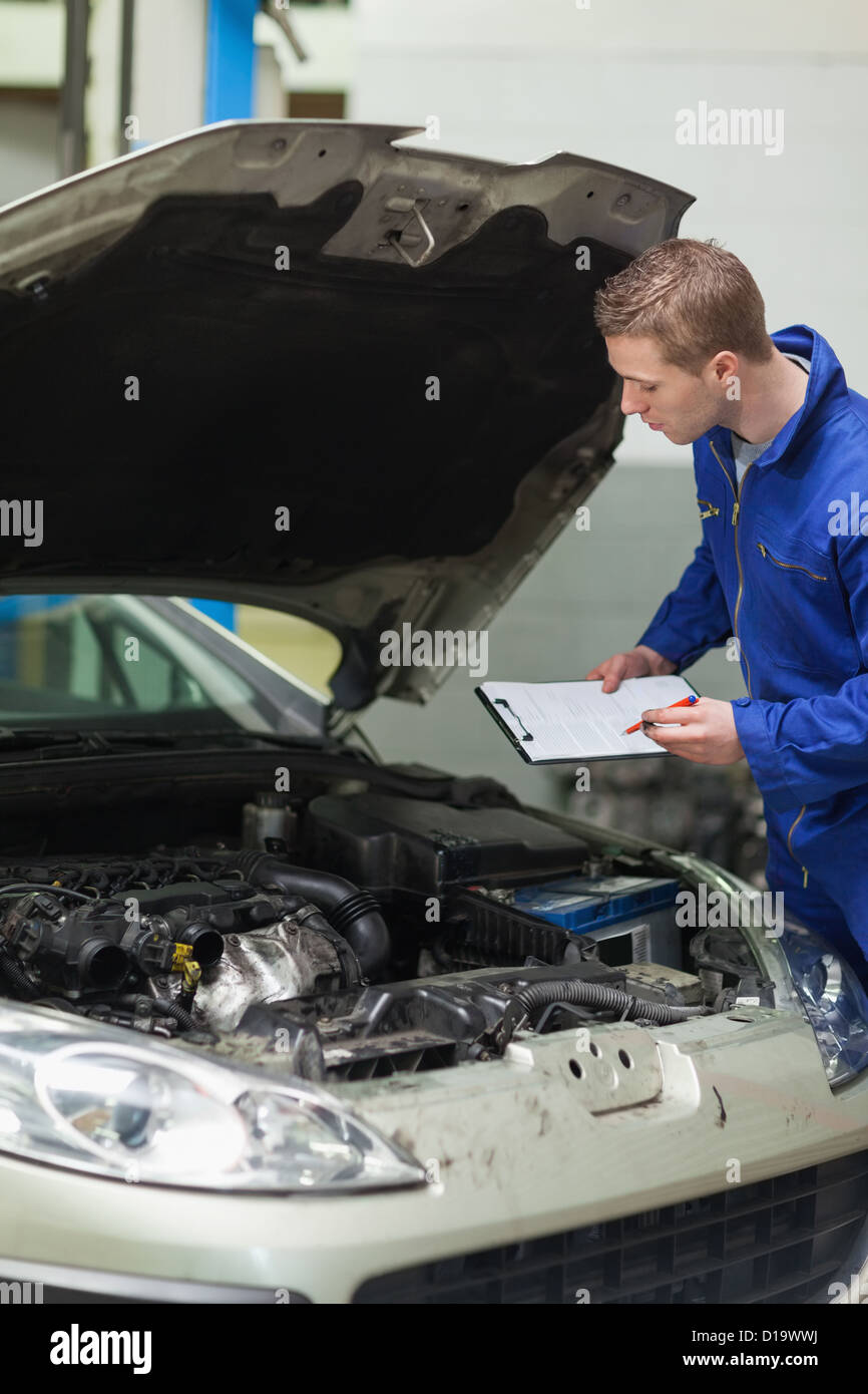 Mechanic checking car engine Stock Photo - Alamy