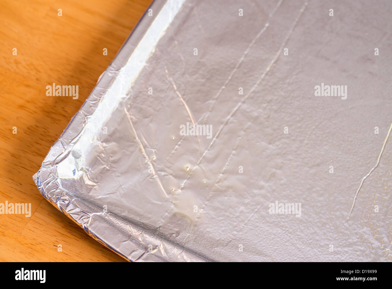 Baking sheet wrapped in aluminum foil and greased with butter Stock ...