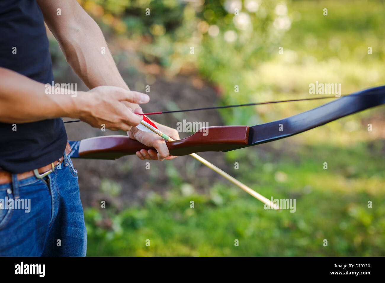 Young archer training with the bow Stock Photo - Alamy