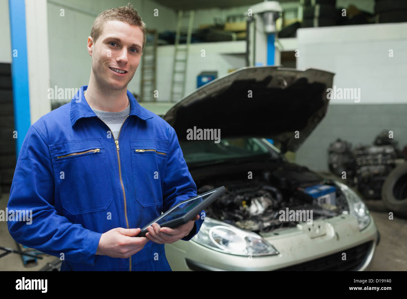 Auto mechanic holding tablet computer Stock Photo - Alamy