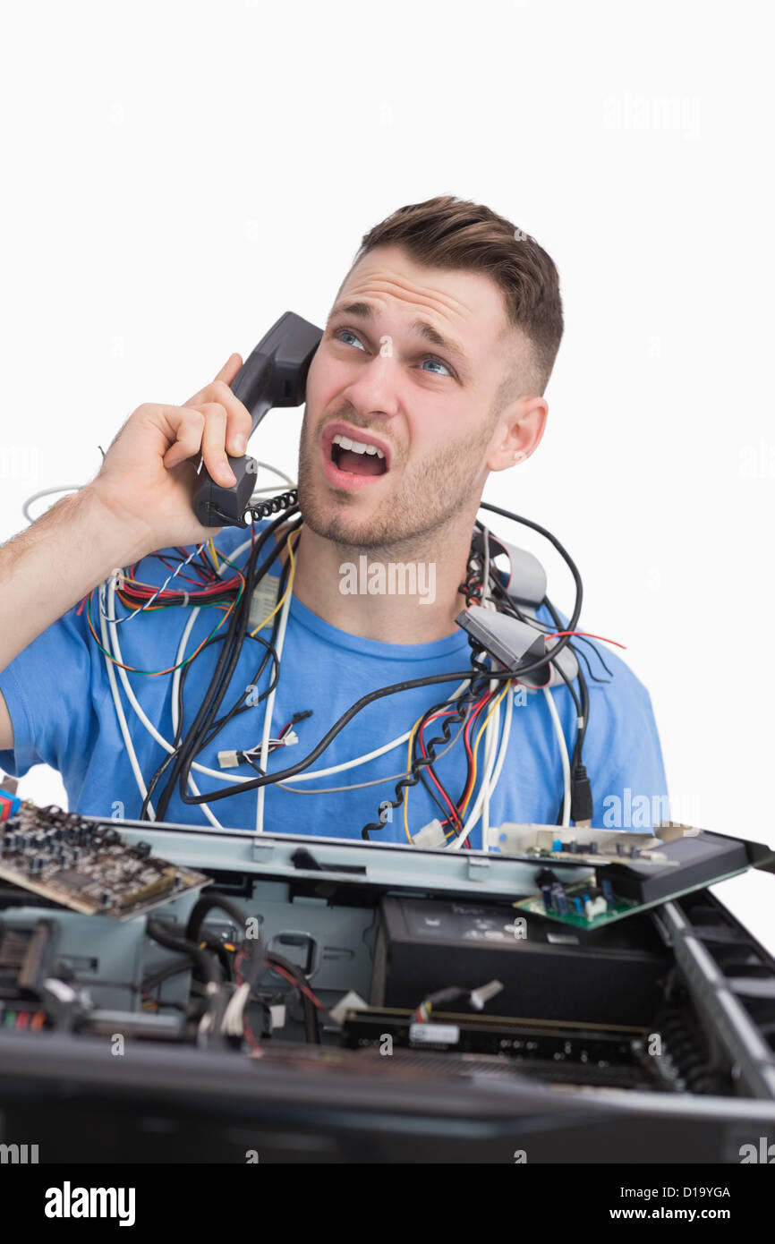 Frustrated computer engineer on call in front of open cpu Stock Photo ...