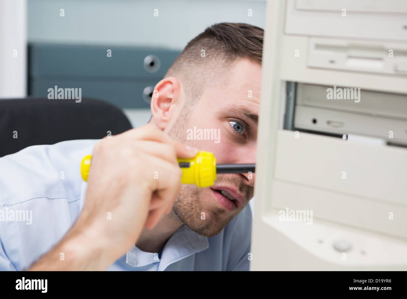 Computer engineer with screw driver fixing cpu Stock Photo - Alamy