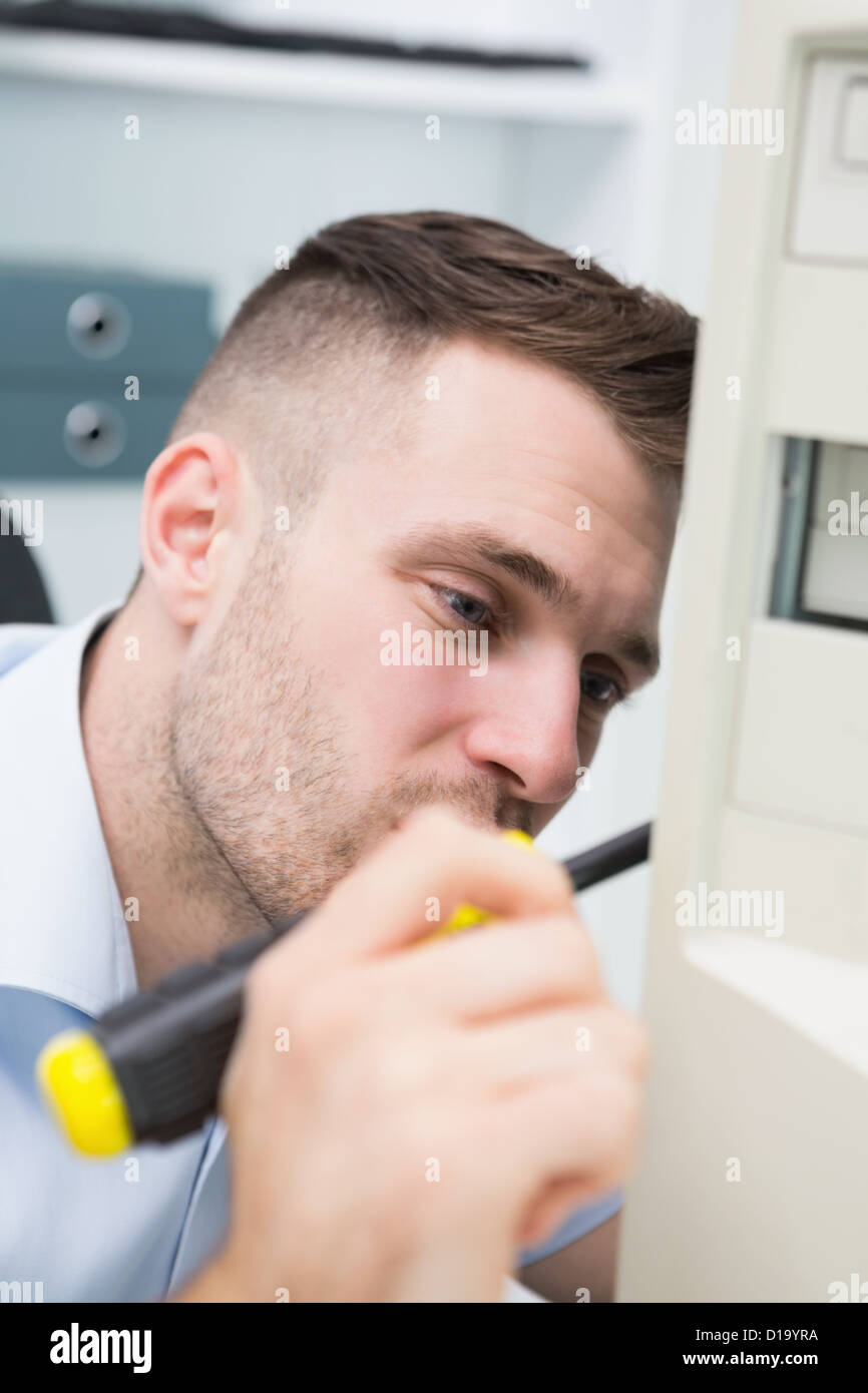 Computer engineer with screw driver fixing cpu Stock Photo - Alamy