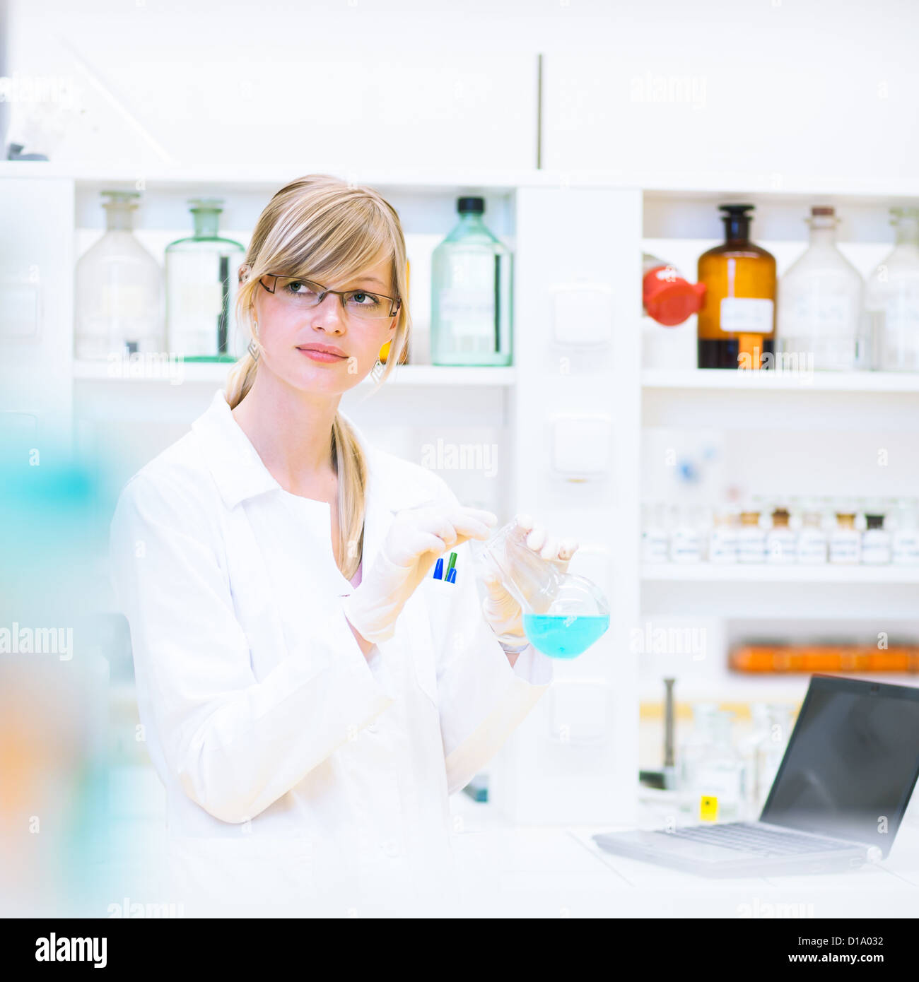 portrait of a female researcher carrying out research in a chemistry ...