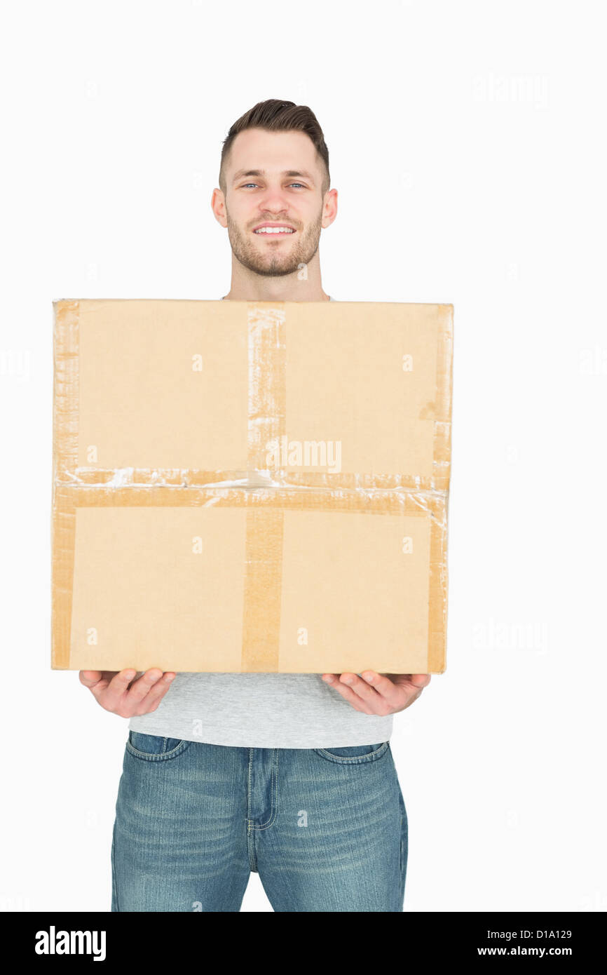 Portrait of young man carrying cardboard box Stock Photo - Alamy