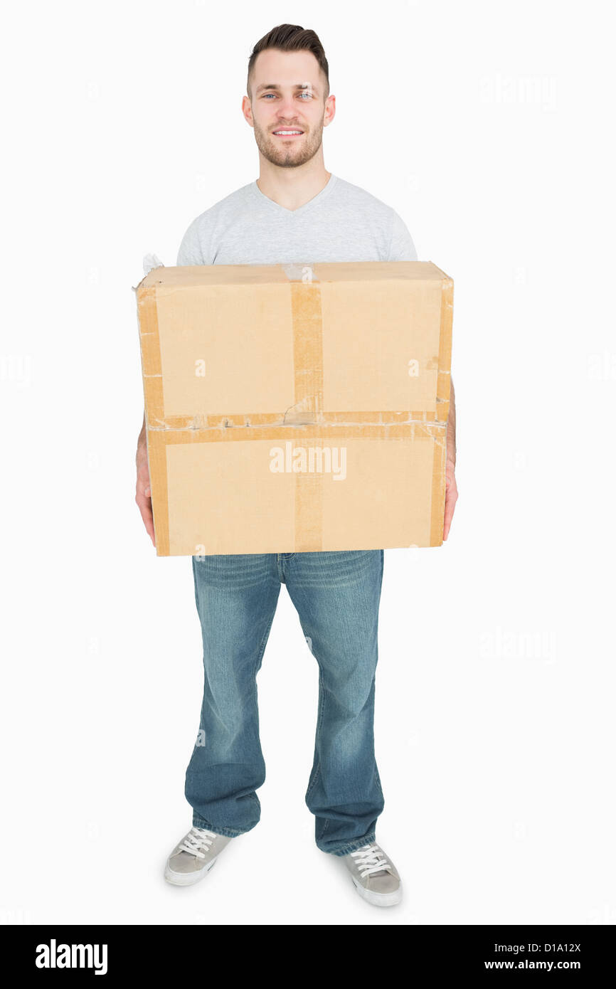 Portrait of young man carrying cardboard box Stock Photo - Alamy