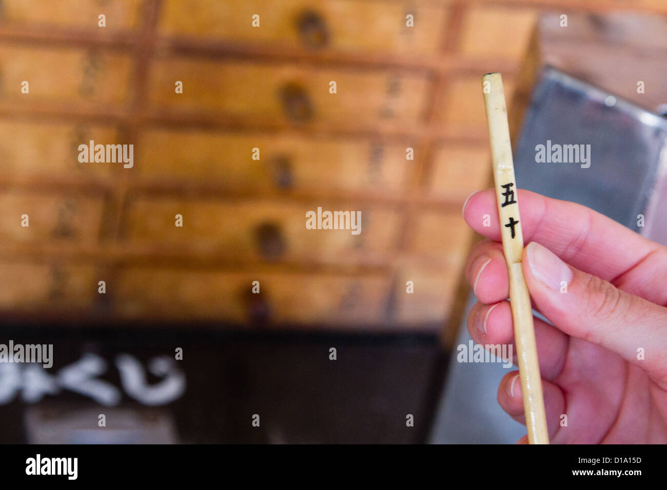 TOKYO, JAPAN A tourist chooses a fortune-telling stick at the Asakusa ...