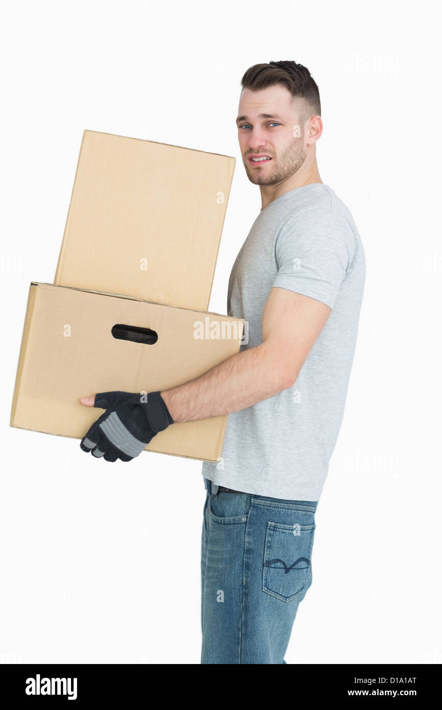 Portrait of tired young man carrying package boxes Stock Photo - Alamy