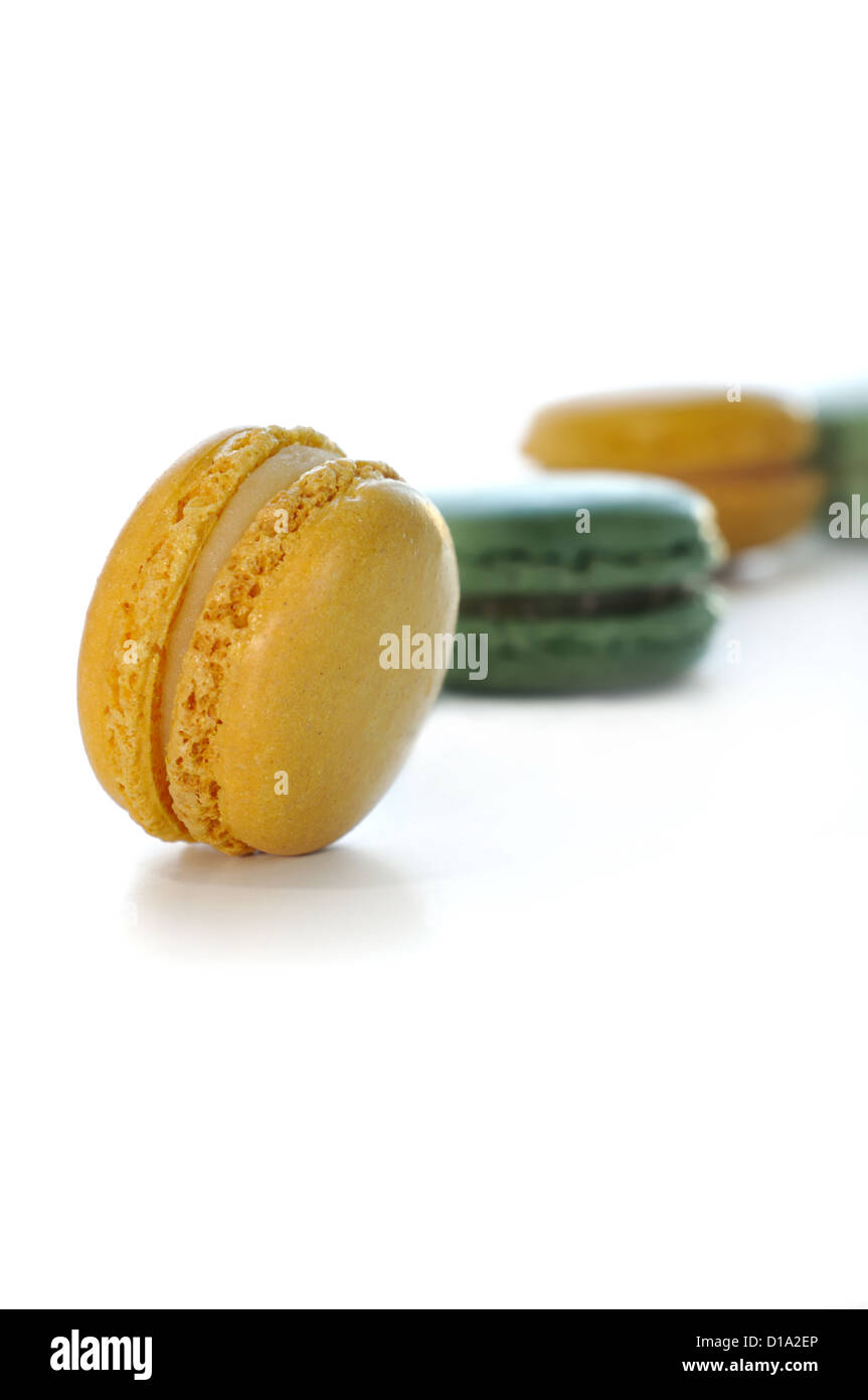 a vanilla macaron standing in front of others on white background Stock ...