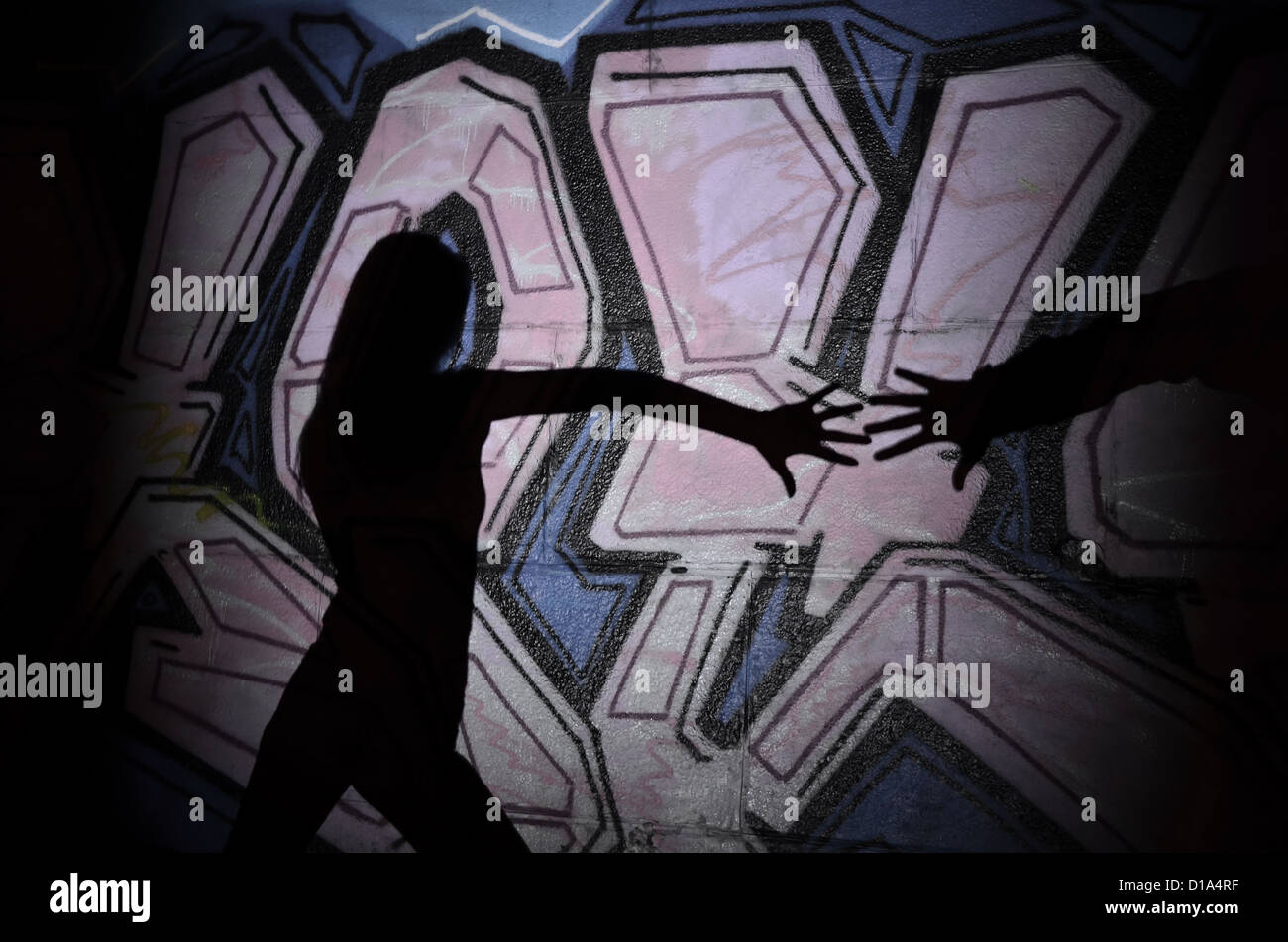 The shadow of the girl and man's hand on a background of graffiti Stock ...