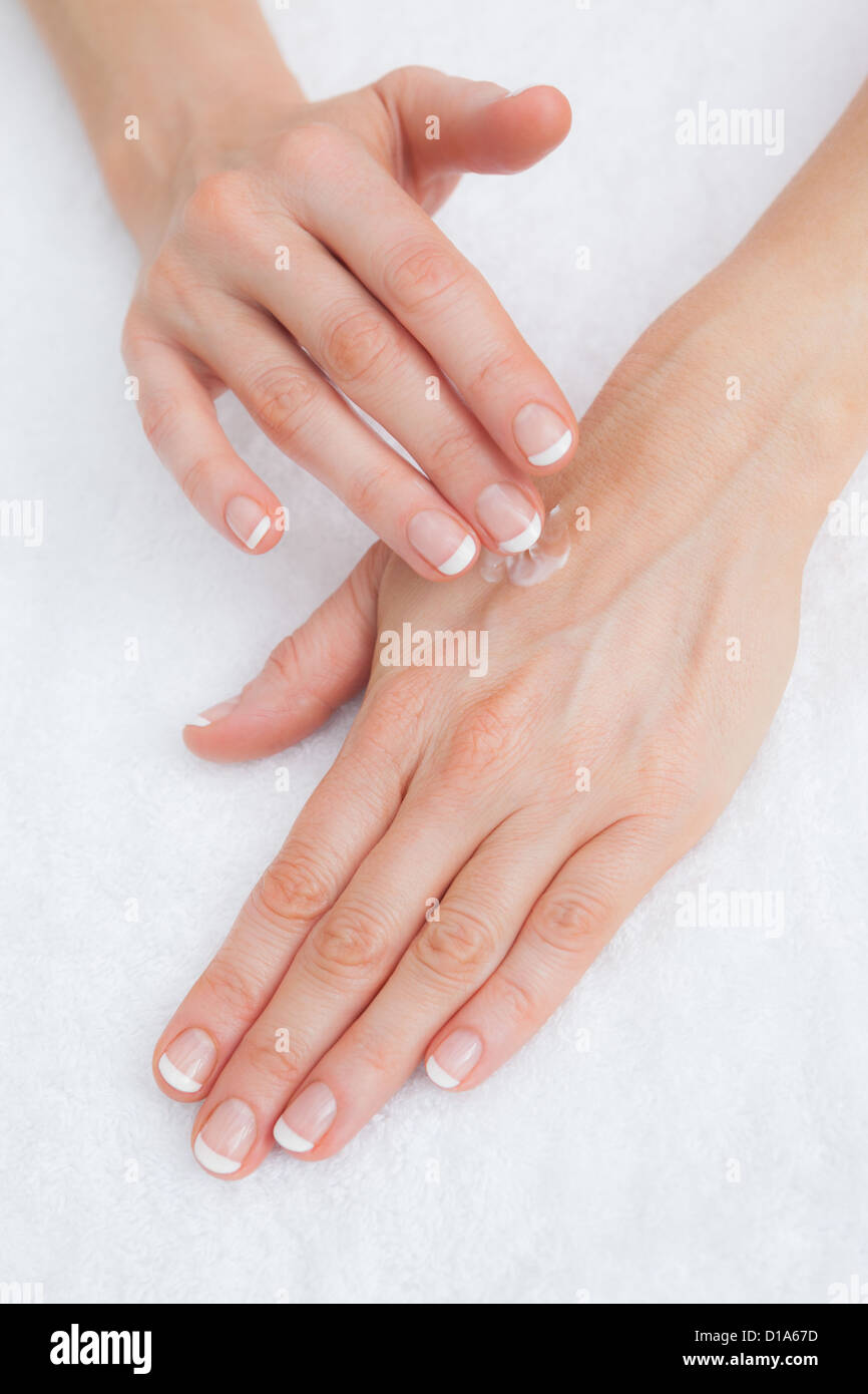 Woman applying cream on hand Stock Photo - Alamy