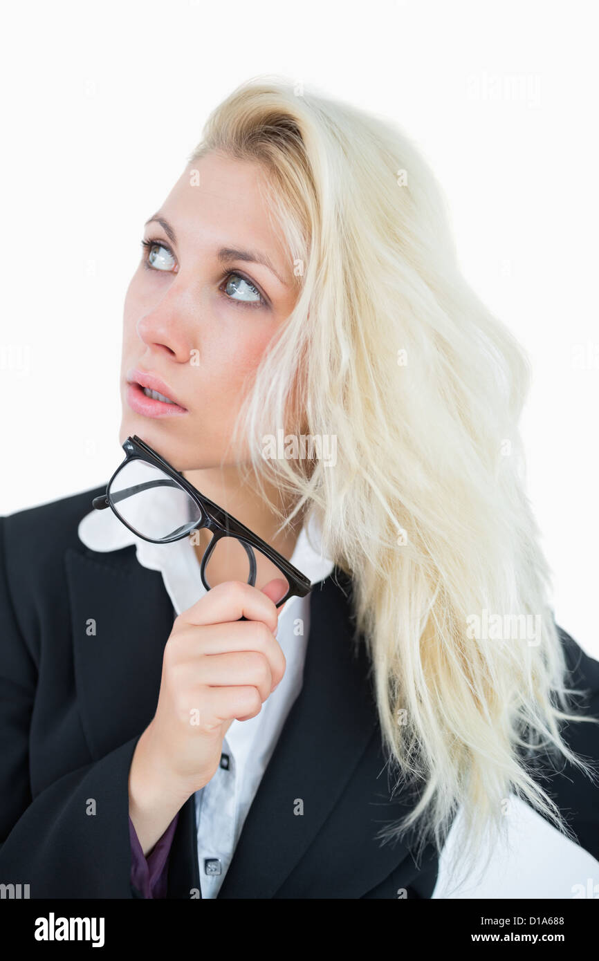 Thoughtful young business woman looking up Stock Photo - Alamy