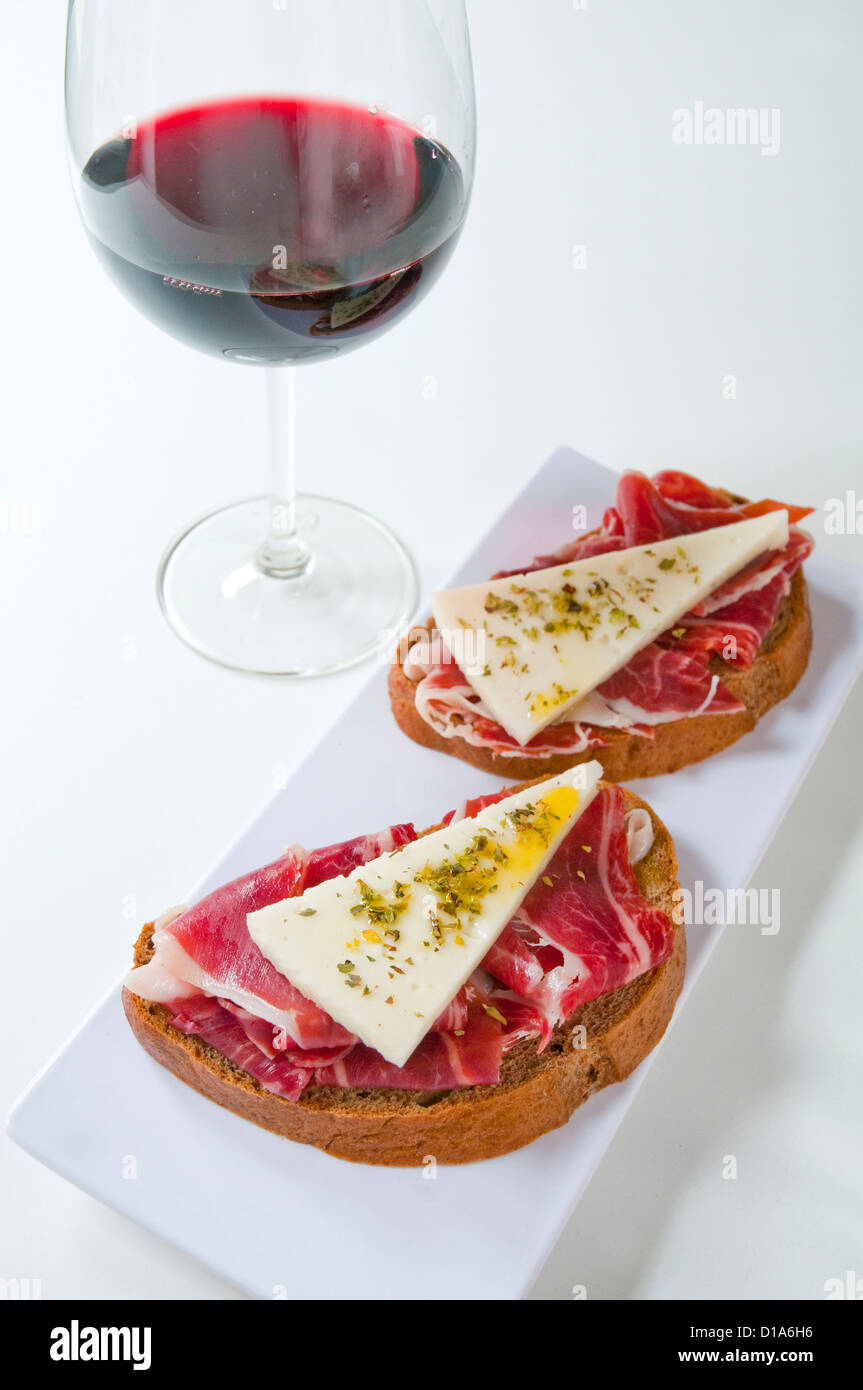 Spanish tapa: Iberian ham with cheese, oregano and olive oil. Spain ...