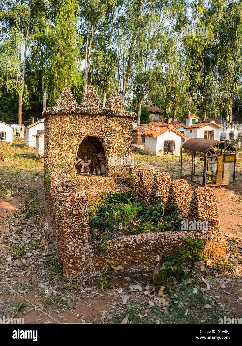 A mausoleum constructed of small river rocks in the municipal cemetery ...