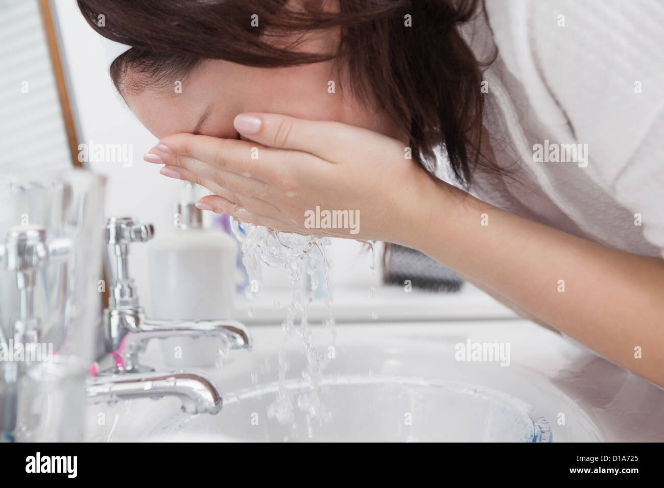Close-up of woman washing face Stock Photo - Alamy