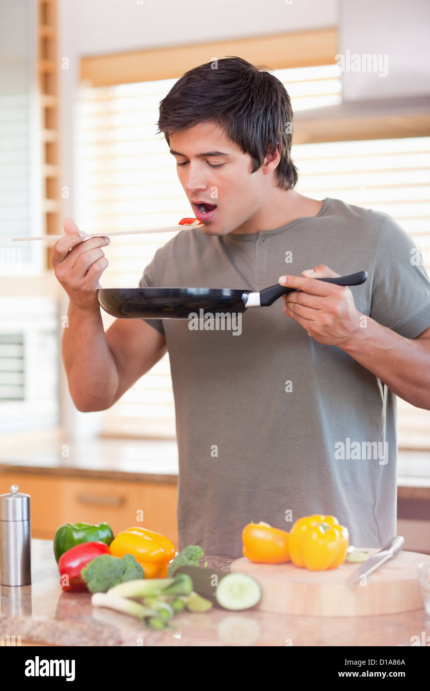 Young man cooking in the kitchen Stock Photo - Alamy