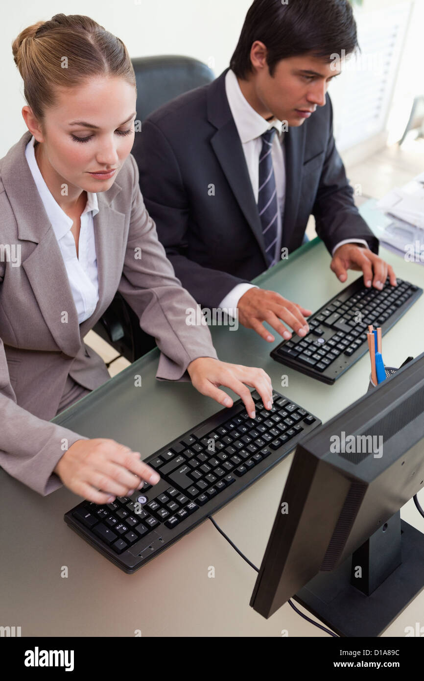 Business colleagues using computers in office Stock Photo - Alamy