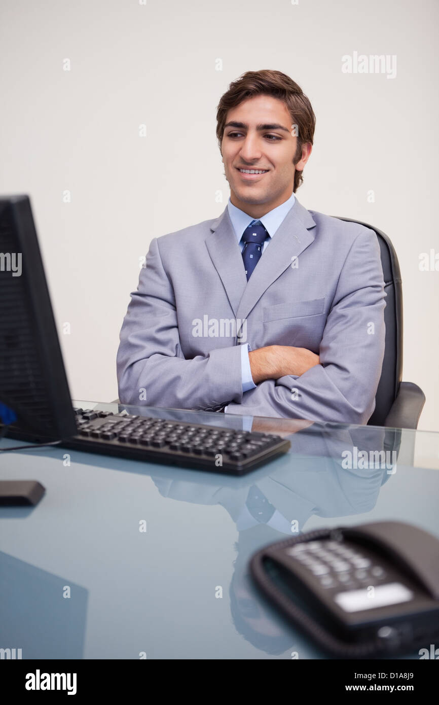 Business man sitting in front of desktop computer Stock Photo - Alamy