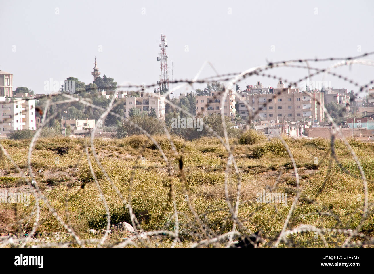 Looking at the Syrian Kurdish city of al-Qamishli from the border fence ...