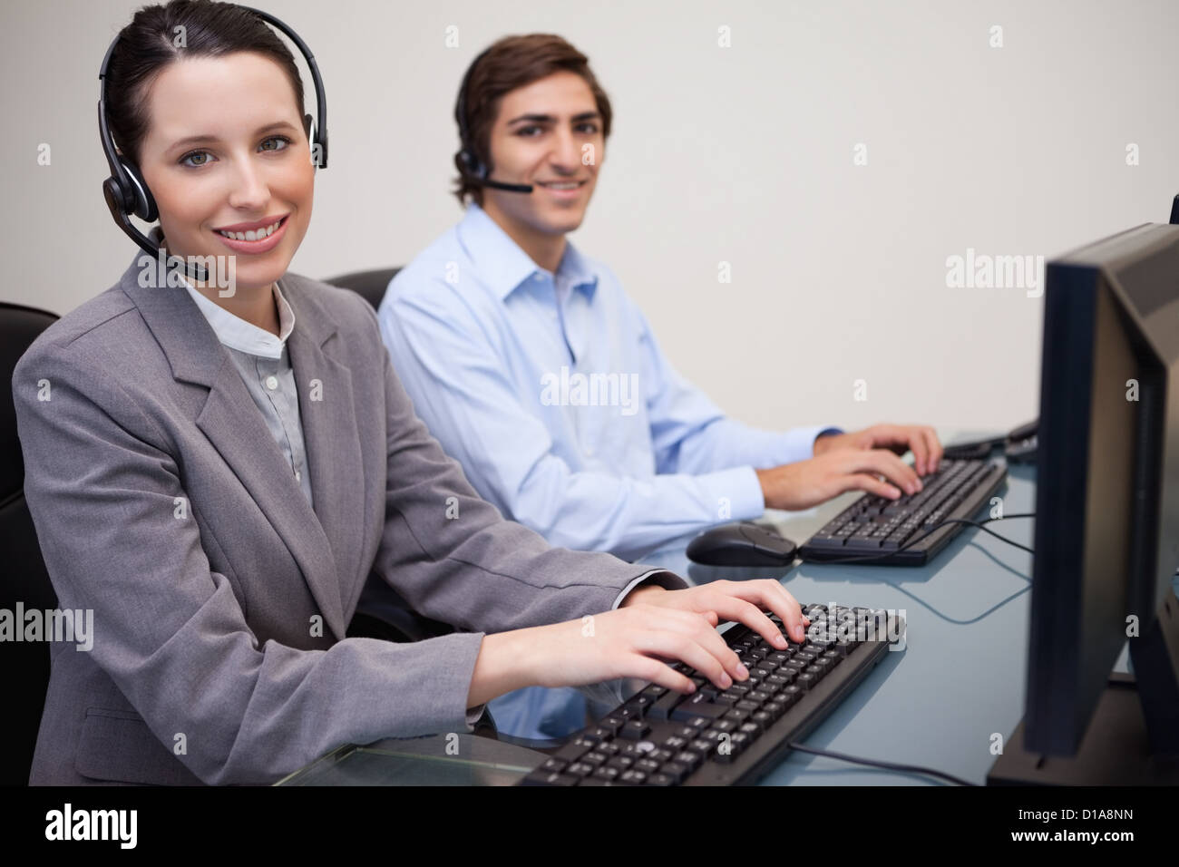Happy call center employees at work Stock Photo - Alamy