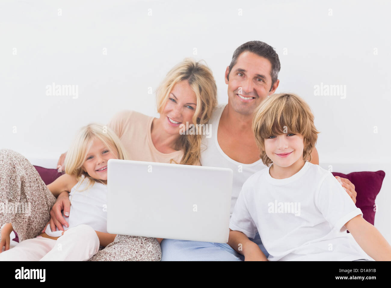 Family using the laptop together Stock Photo - Alamy