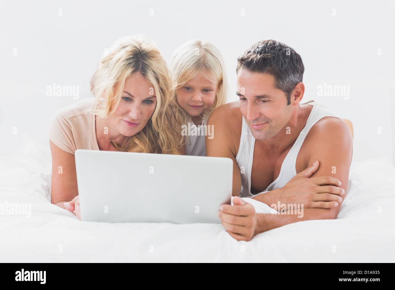 Calm family using together a laptop Stock Photo - Alamy