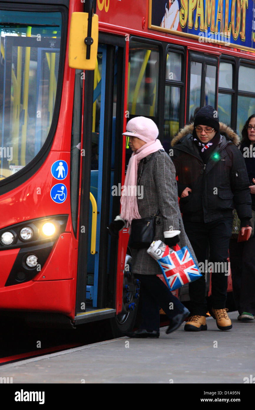 A queue of people boarding a red London bus Stock Photo - Alamy