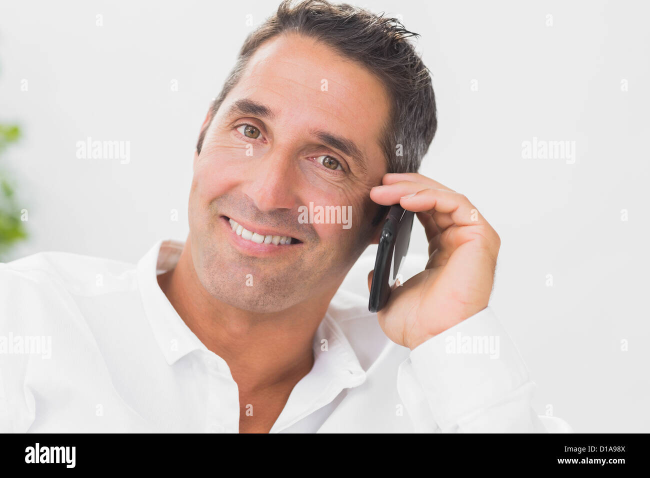 Smiling man phoning Stock Photo - Alamy