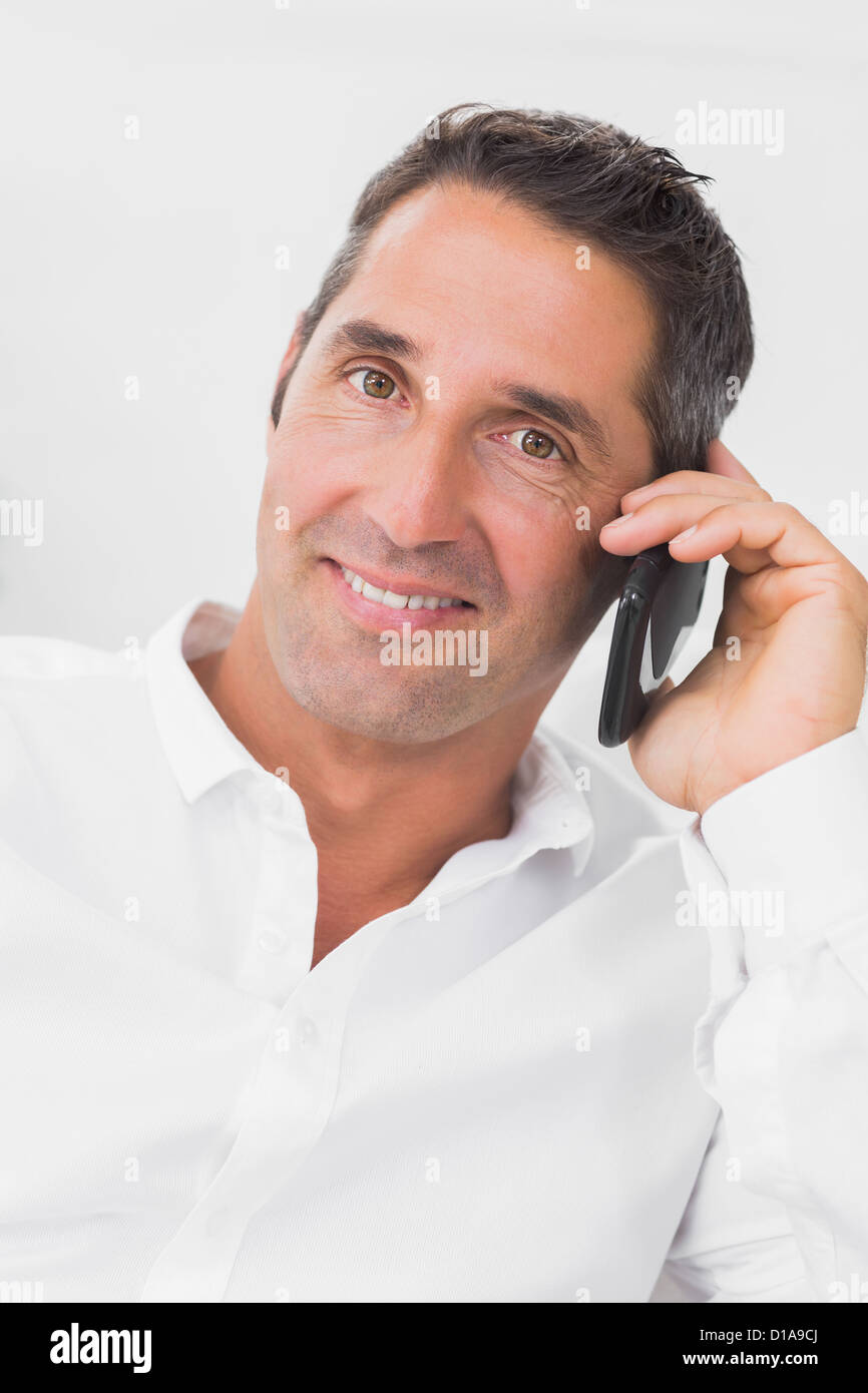 Man looking happy and talking on the phone Stock Photo - Alamy