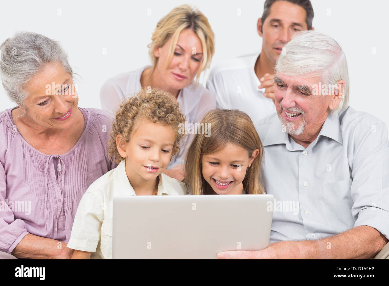 Joyful family watching a laptop screen together Stock Photo - Alamy