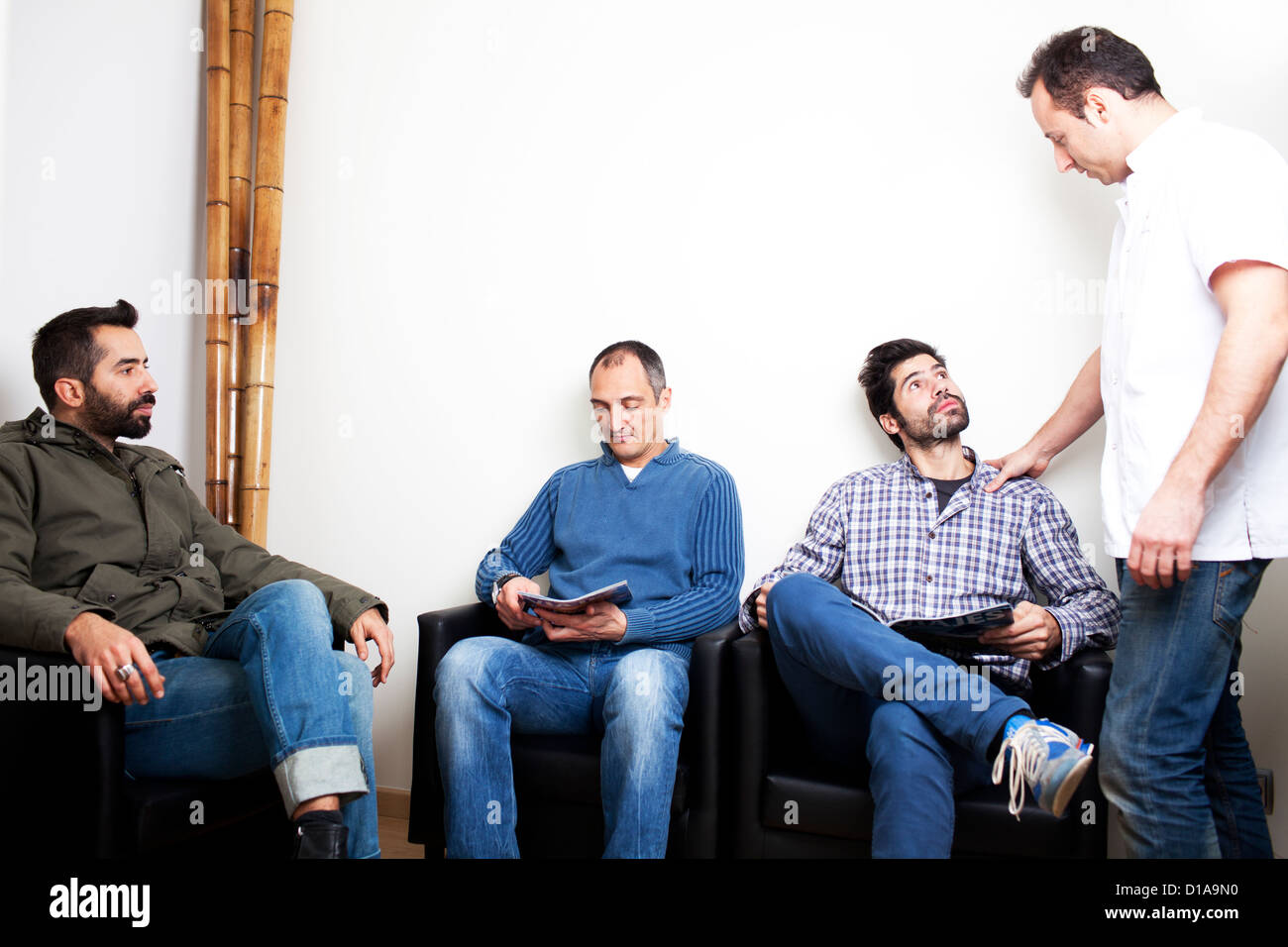 Doctor saying hello to patient in waiting room Stock Photo - Alamy