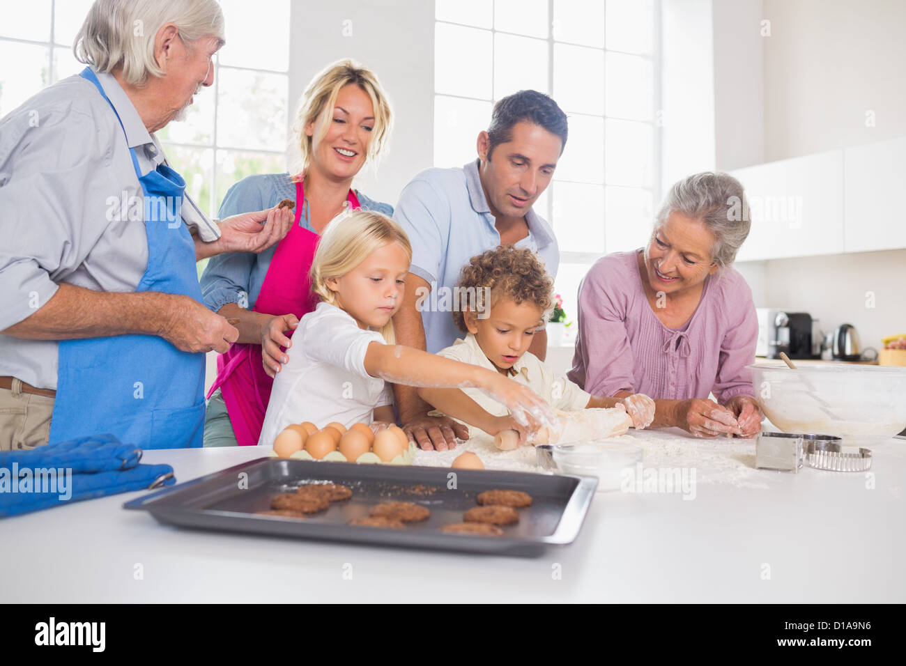 Family preparing biscuits together Stock Photo - Alamy
