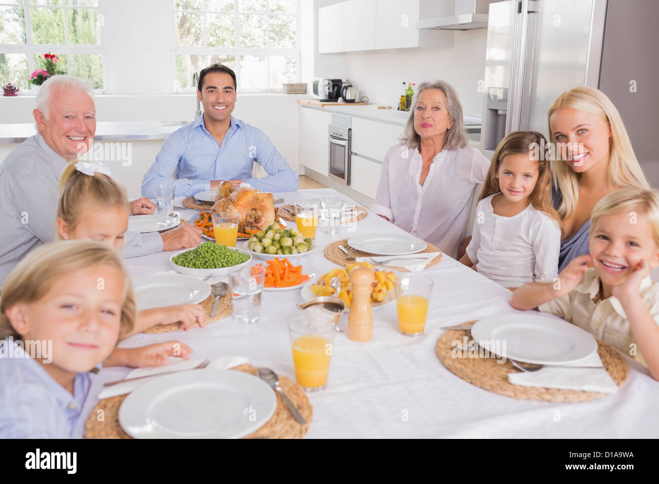 Family sitting for dinner Stock Photo - Alamy