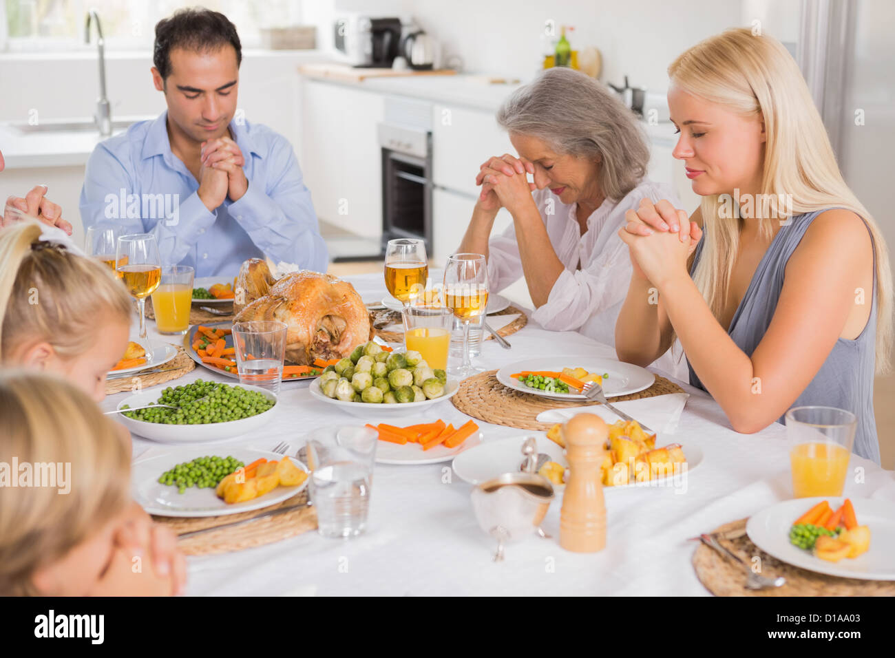 Family praying before dinner Stock Photo - Alamy