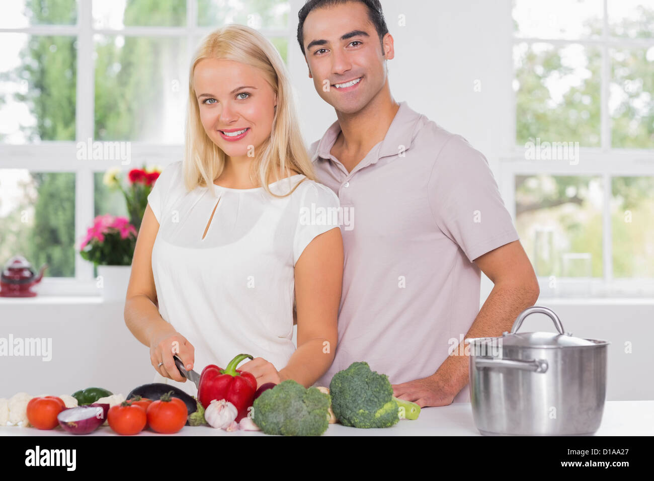 Blonde woman cooking with her husband Stock Photo - Alamy