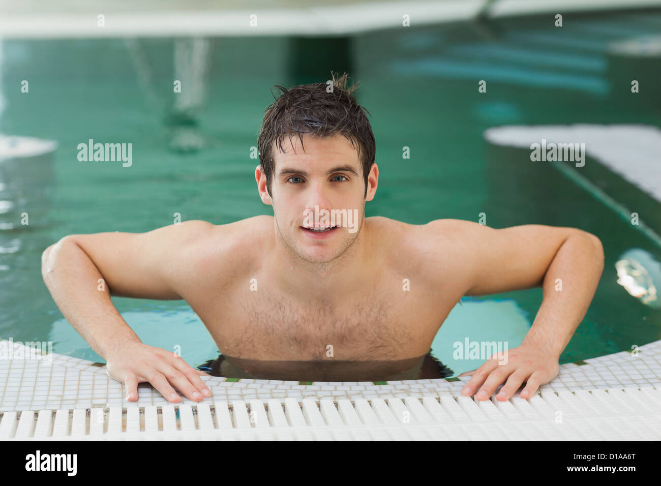 Man getting out of swimming pool Stock Photo - Alamy