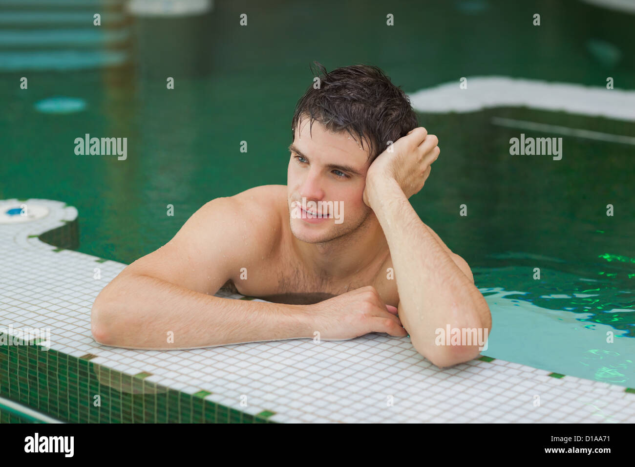 Smiling man relaxing in the pool Stock Photo - Alamy