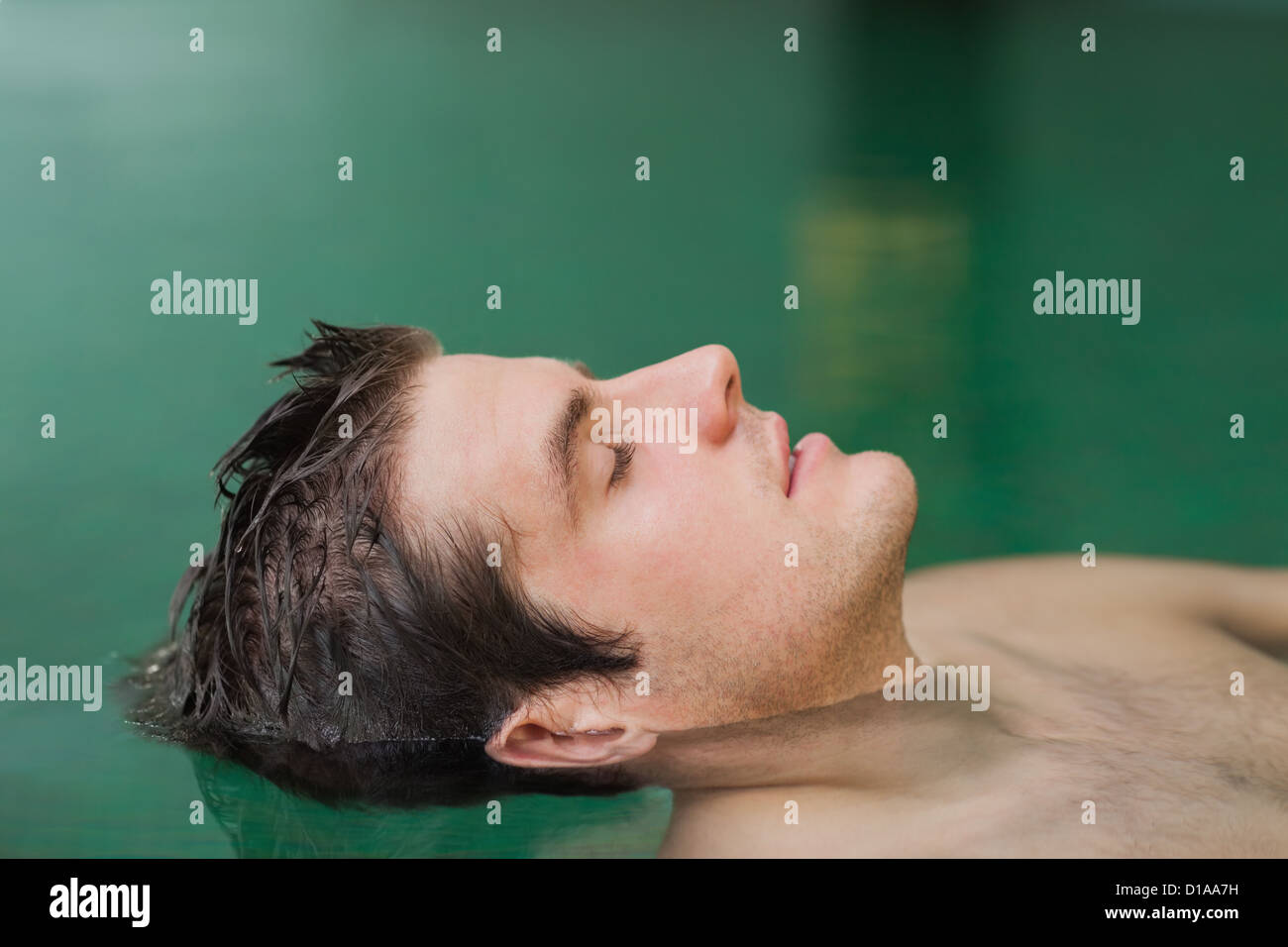 Handsome man floating in the pool Stock Photo - Alamy