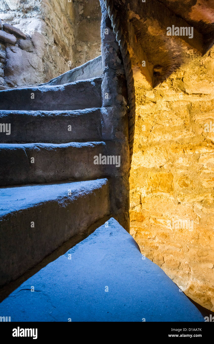 Stone Spiral Stairway with warm and cold light Stock Photo - Alamy
