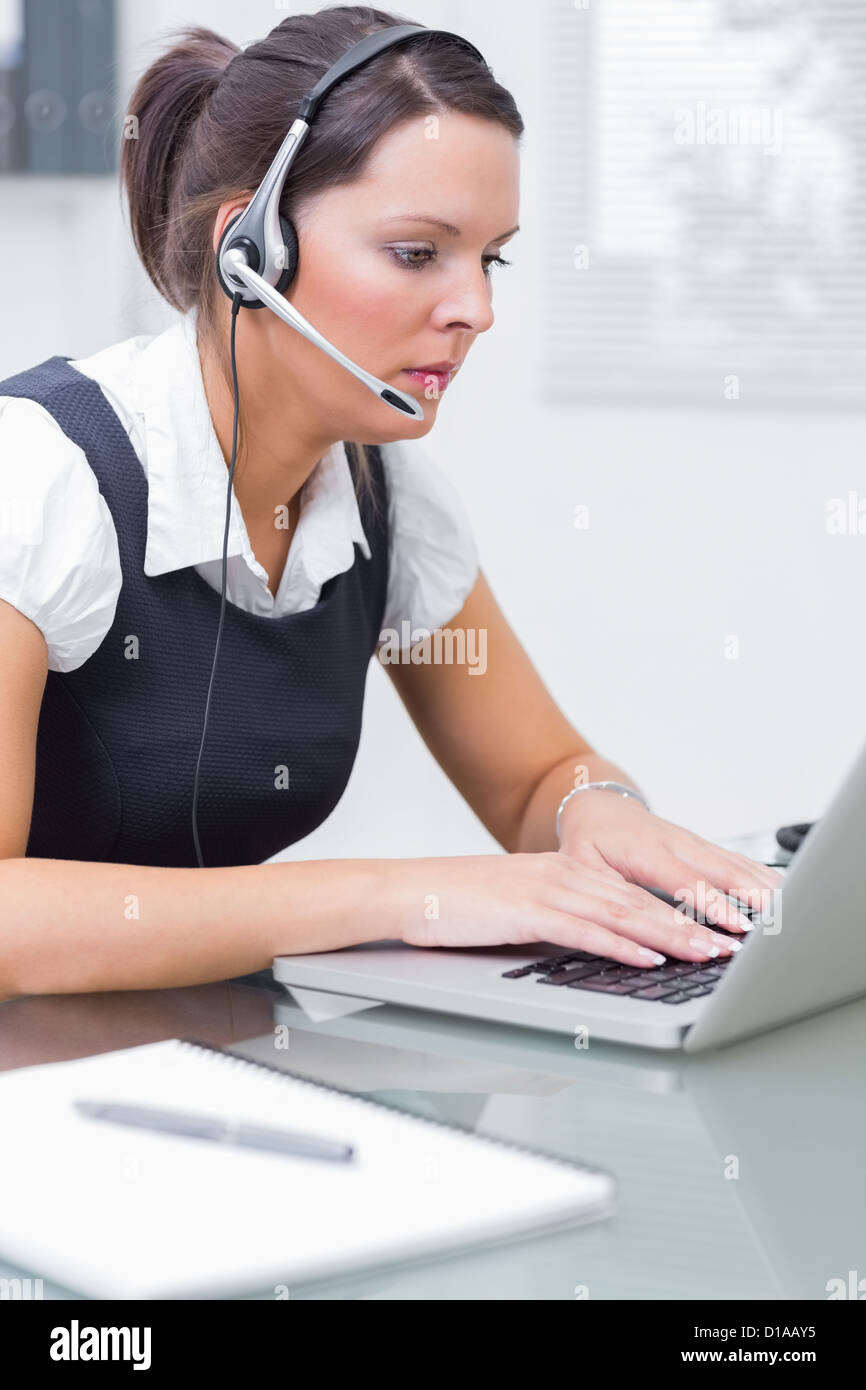 Business woman wearing headset in office Stock Photo - Alamy