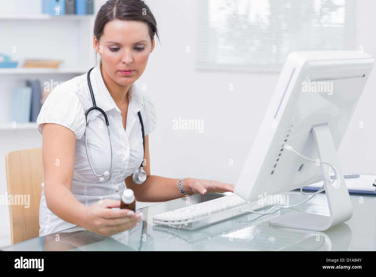 Doctor using computer to prepare an online prescription Stock Photo - Alamy