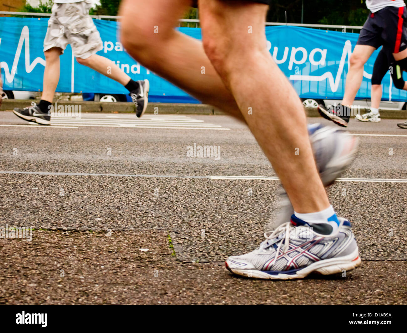 The legs of a runner taking part in a fun run Stock Photo - Alamy