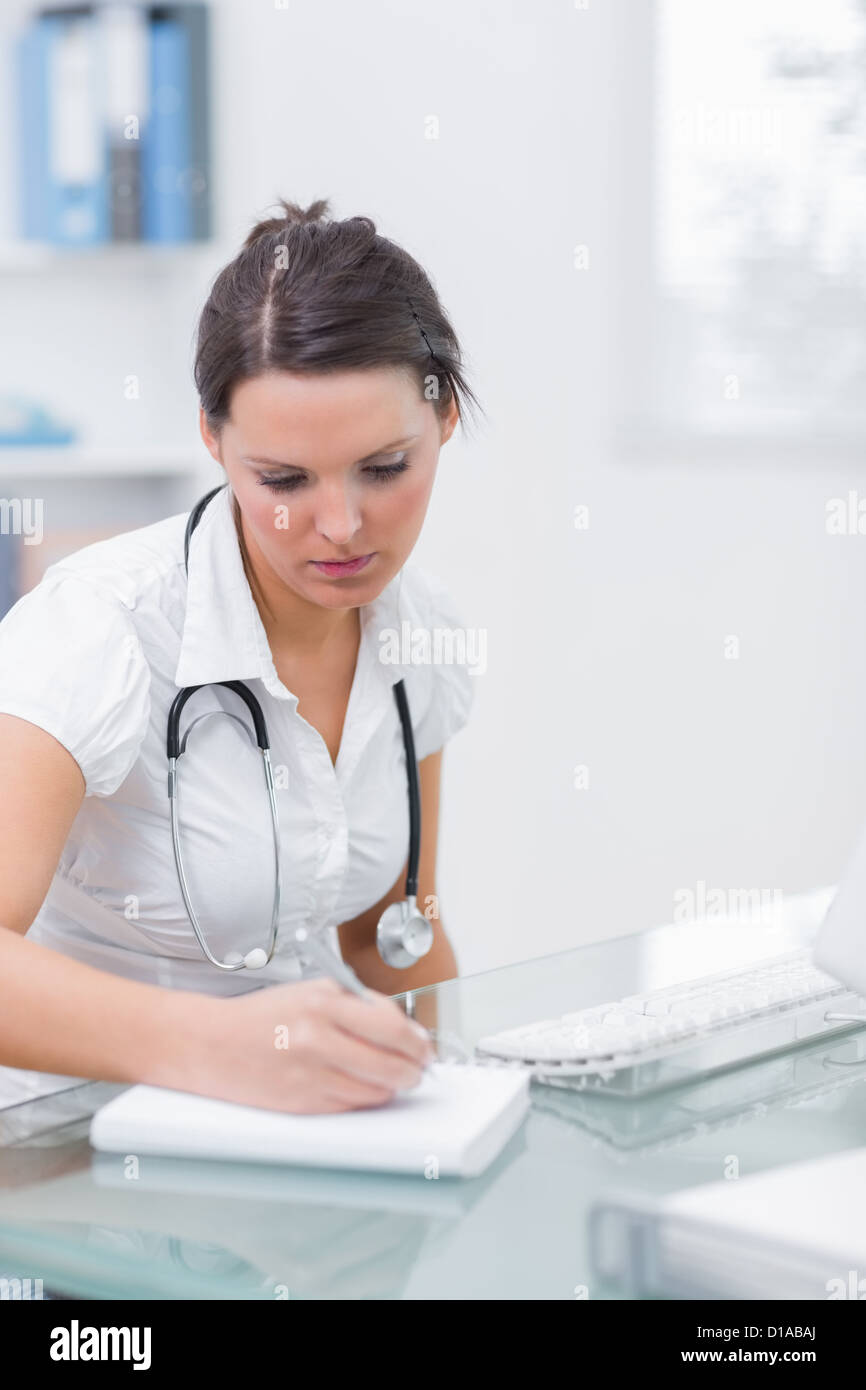 Doctor writing a prescription at clinic Stock Photo - Alamy