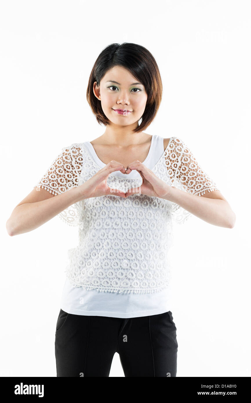Pretty Chinese lady making a heart shape sign with her hands Stock ...
