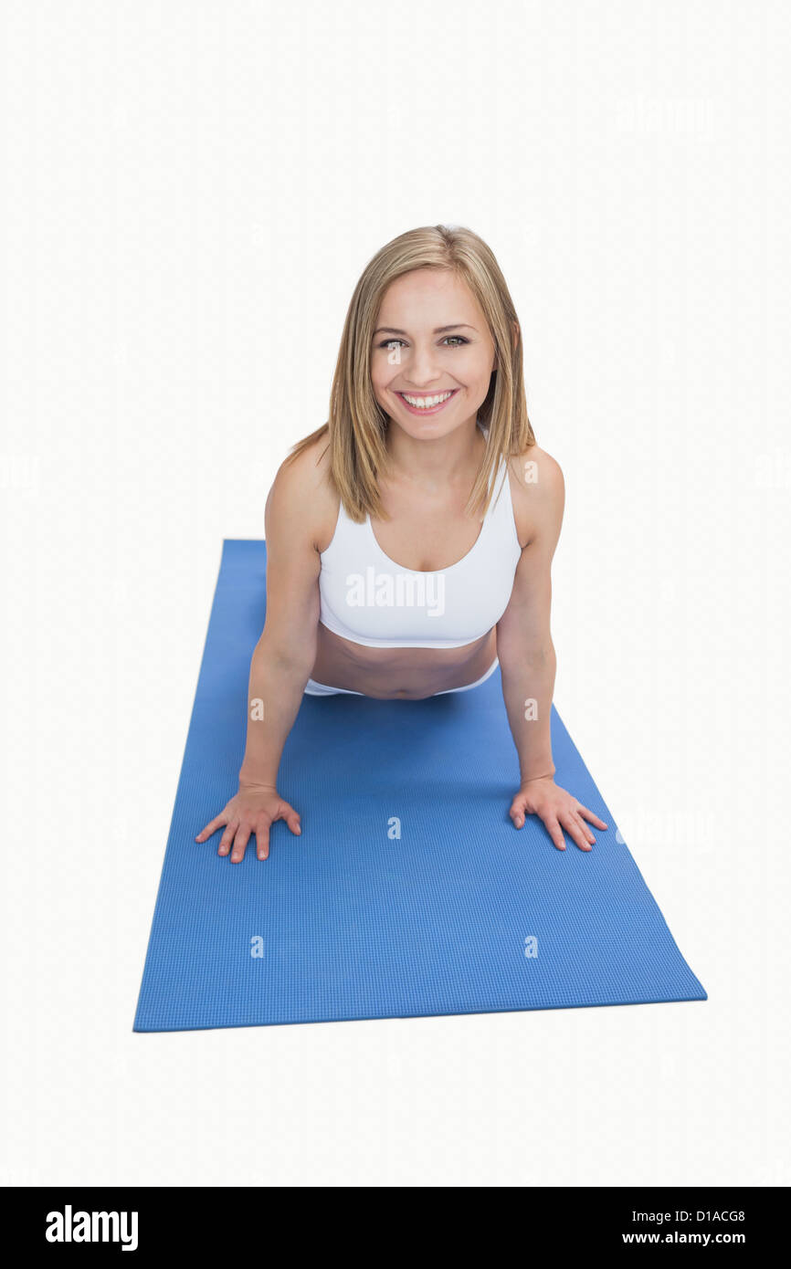 Portrait of happy woman doing push-ups on exercise mat Stock Photo - Alamy
