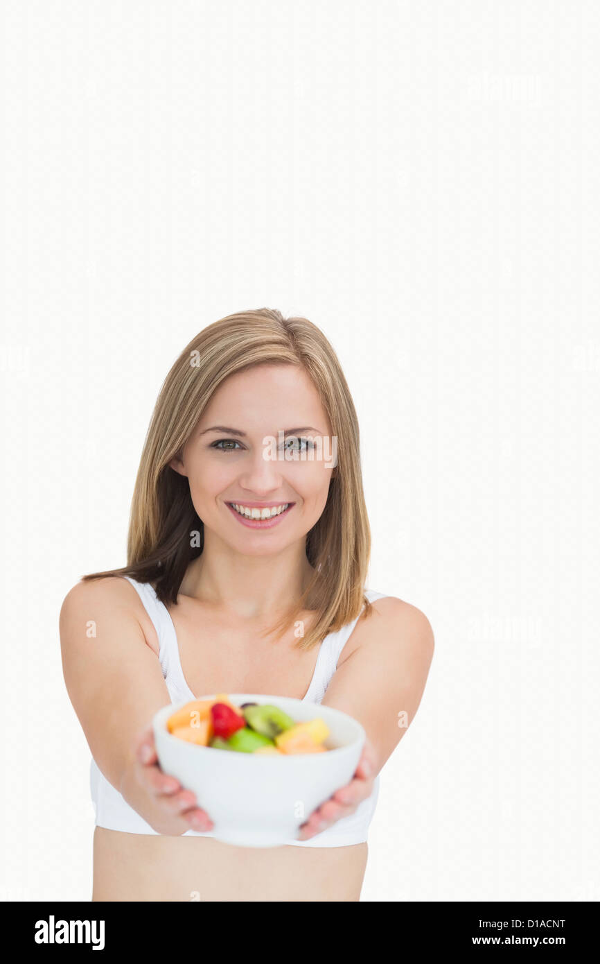 Portrait of woman offering you bowl of fruits Stock Photo - Alamy