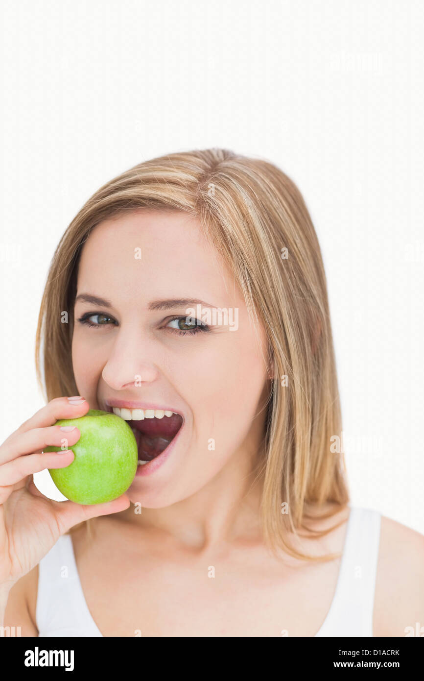 Close-up portrait of woman eating green apple Stock Photo - Alamy