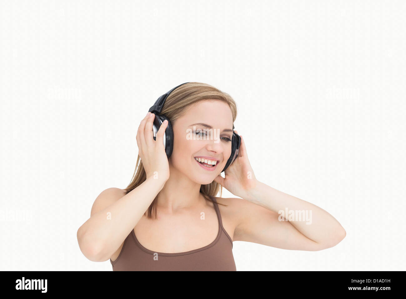 Young woman listening music through headphones Stock Photo - Alamy