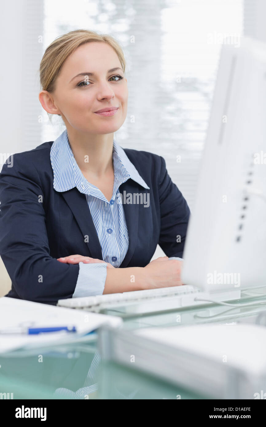 Confident business woman with computer at office desk Stock Photo - Alamy