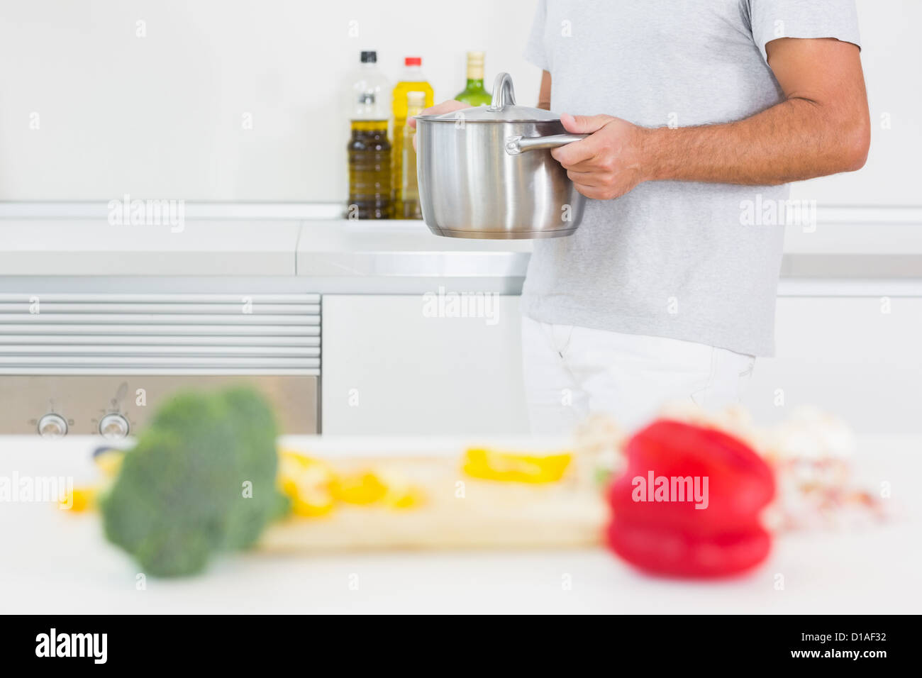 Man carrying large pot Stock Photo - Alamy